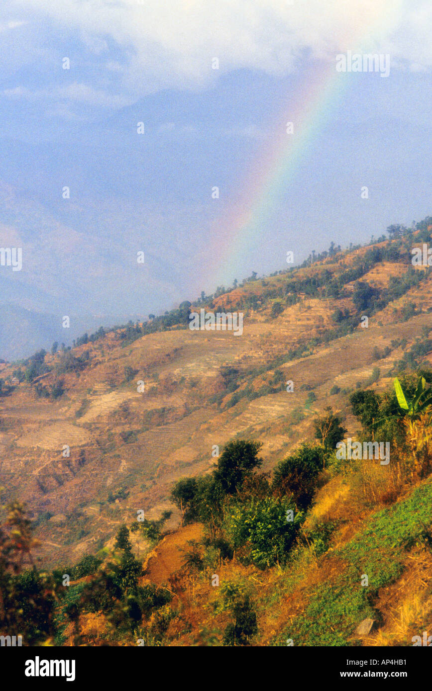 A rare rainbow crosses a landscape in the Kingdom of Nepal, Himalayas ...