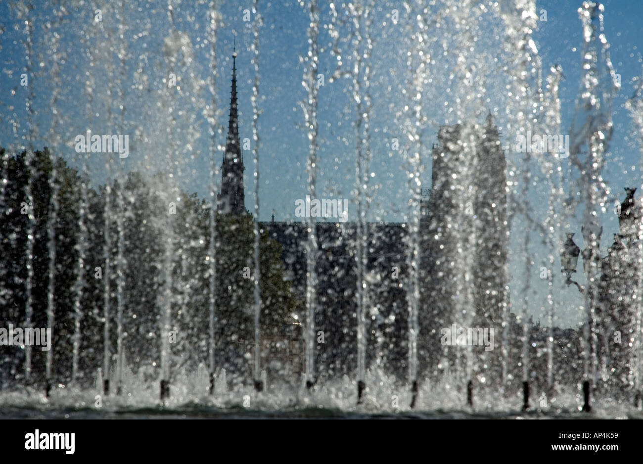 Silhouette of the cathedral of Notre Dame behind water jet Stock Photo ...