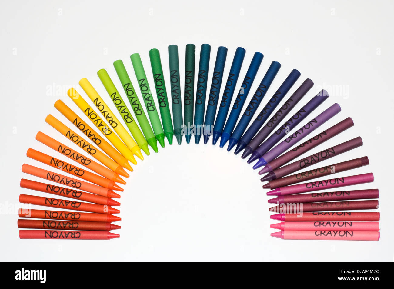 Colored Crayons arranged in a rainbow shape on white background Stock ...