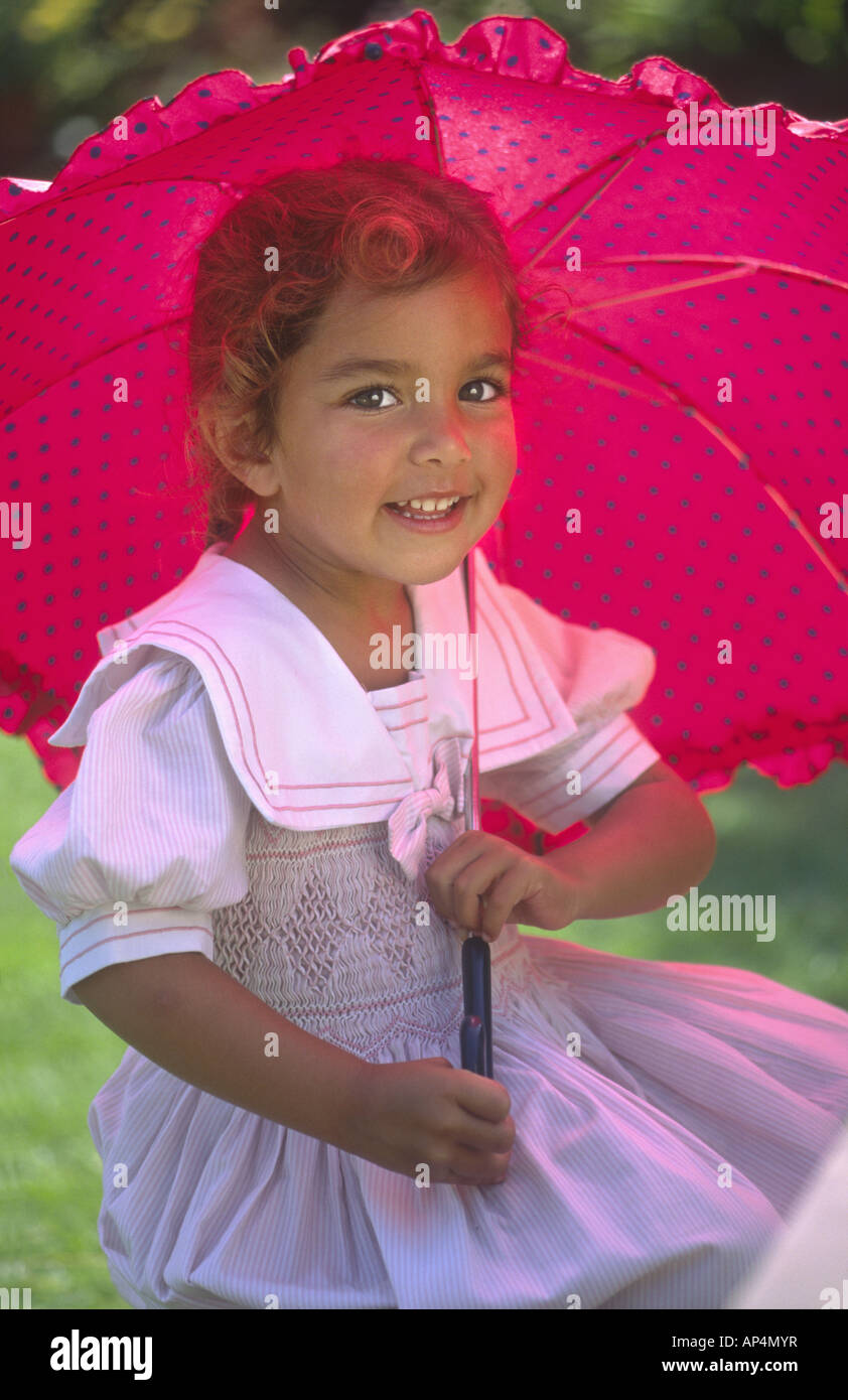 Young Girl Sitting Under a Parasol in Garden Stock Photo - Alamy