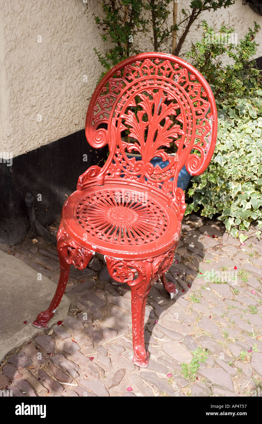 Red Painted Wrought Iron Chair outside Restaurant at Dunster Somerset ...