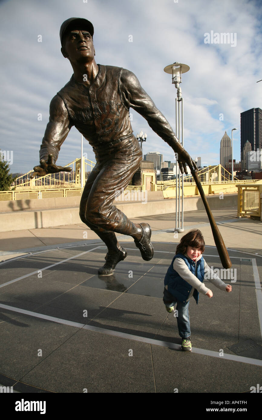 Boy in front of Roberto Clemente statue pretending to hit a home run ...