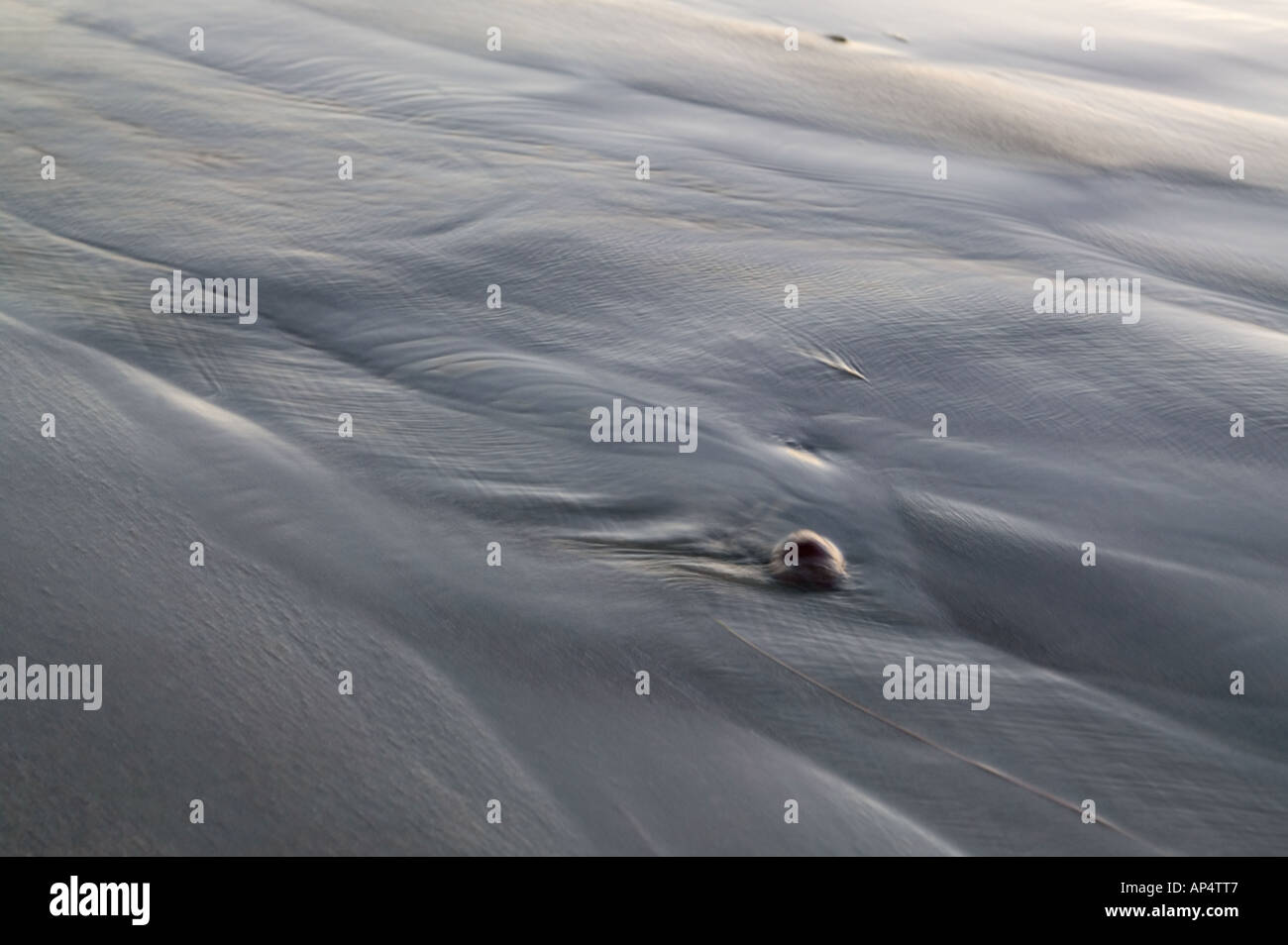 Waves lapping onto a coastal shore Stock Photo - Alamy