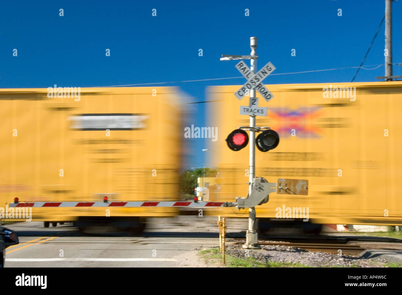 A train in motion passes through a railroad crossing in Iowa Stock ...