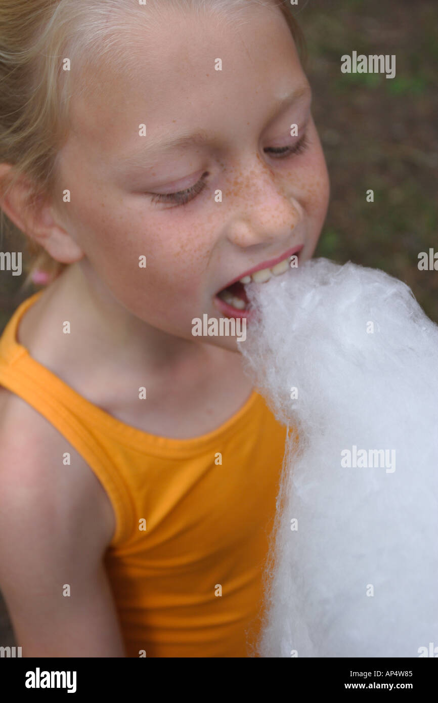 Girl eating candy Stock Photo - Alamy