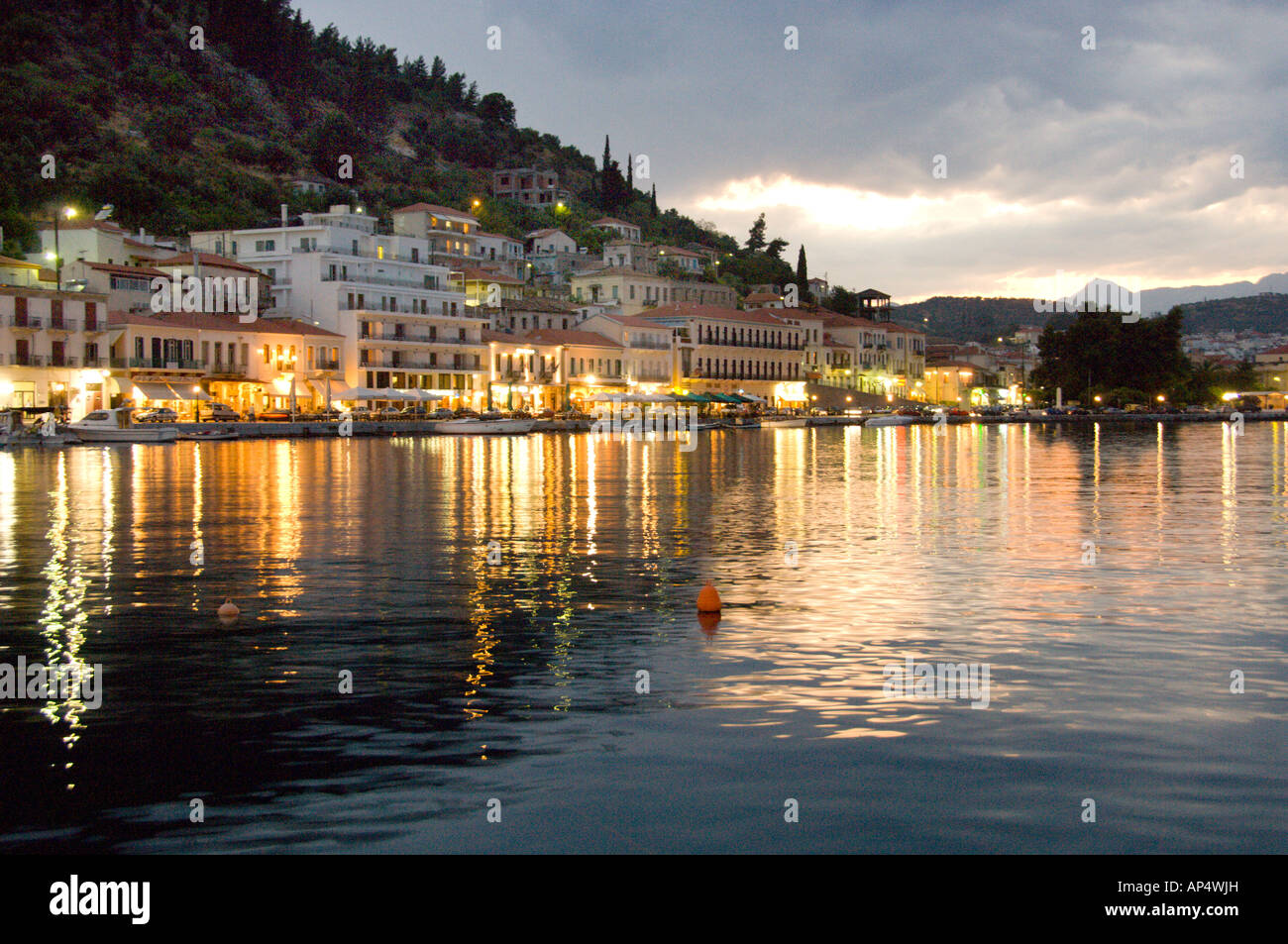 Village lights reflected in the calm waters of the harbour of Githeo ...