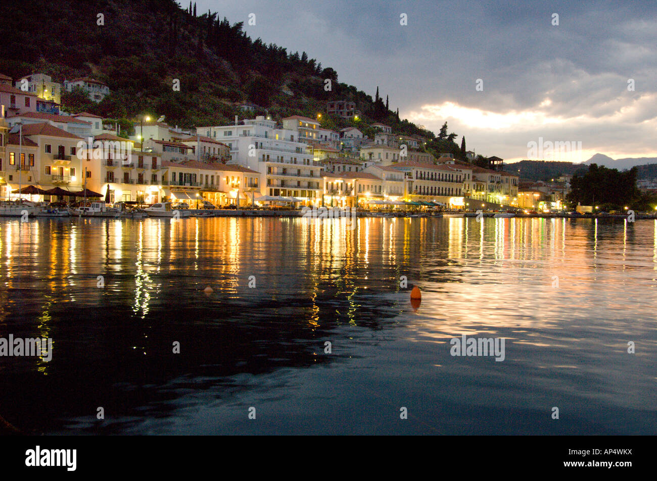 Village lights reflected in the calm waters of the harbour of Githeo ...