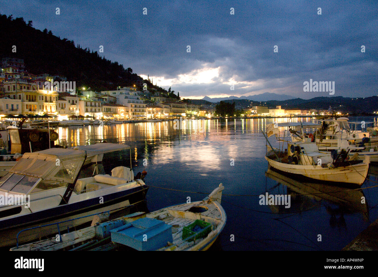 Village lights reflected in the calm waters of the harbour of Githeo ...