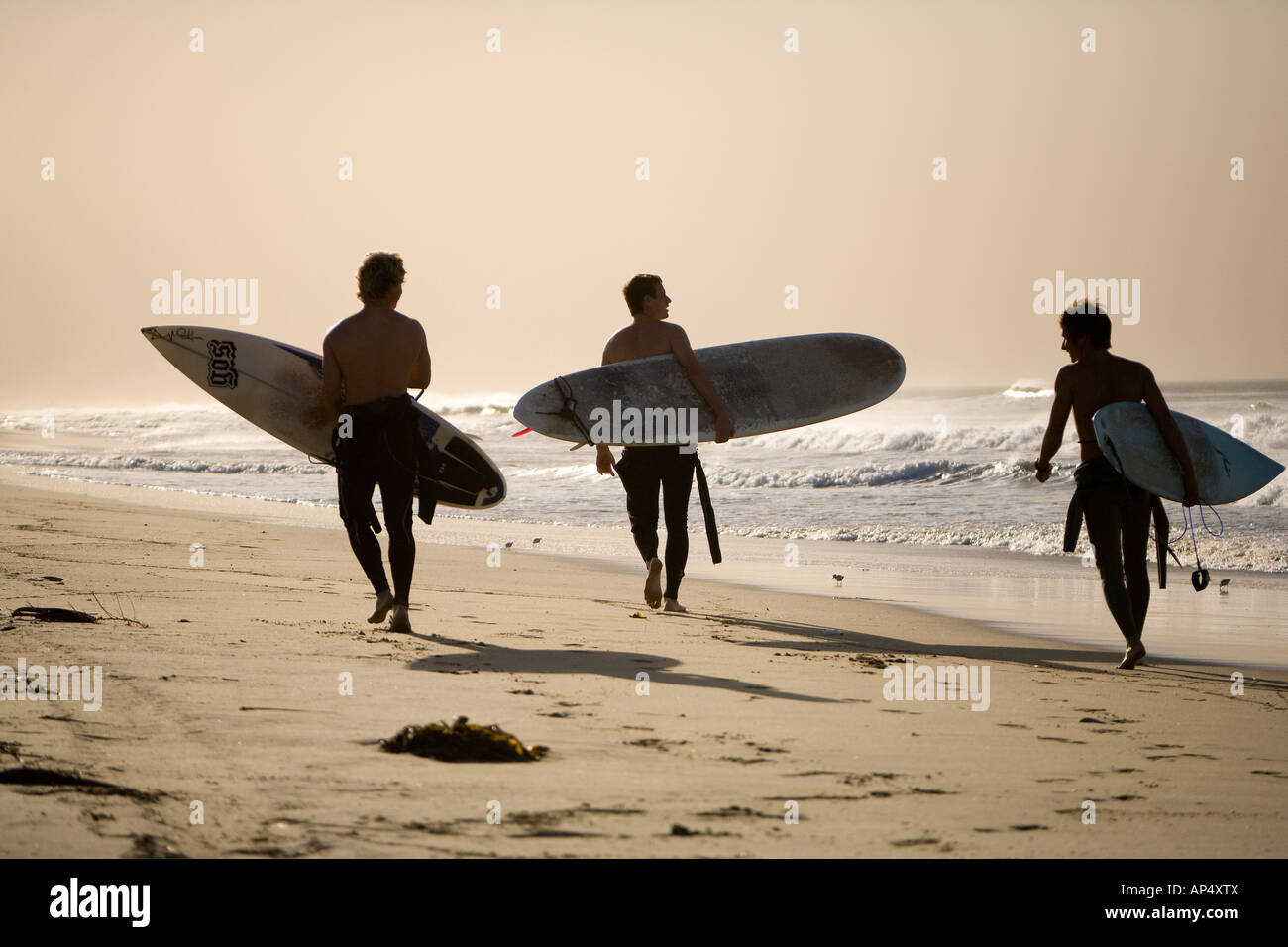 three surfers at huntington beach Stock Photo - Alamy