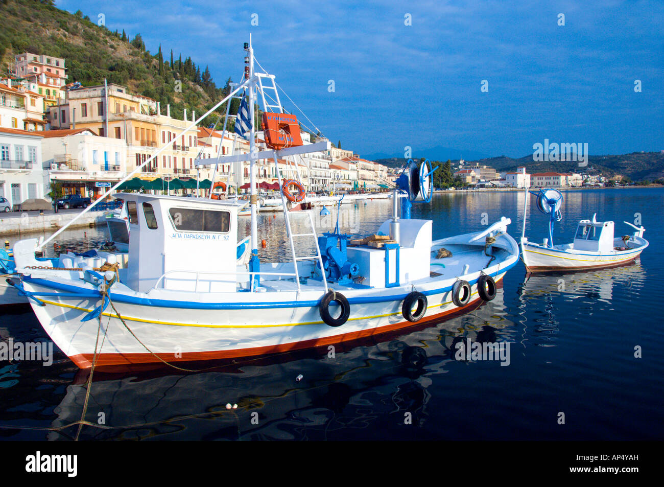 Pastel colored buildings on the waterfront and colorful fishing boats ...