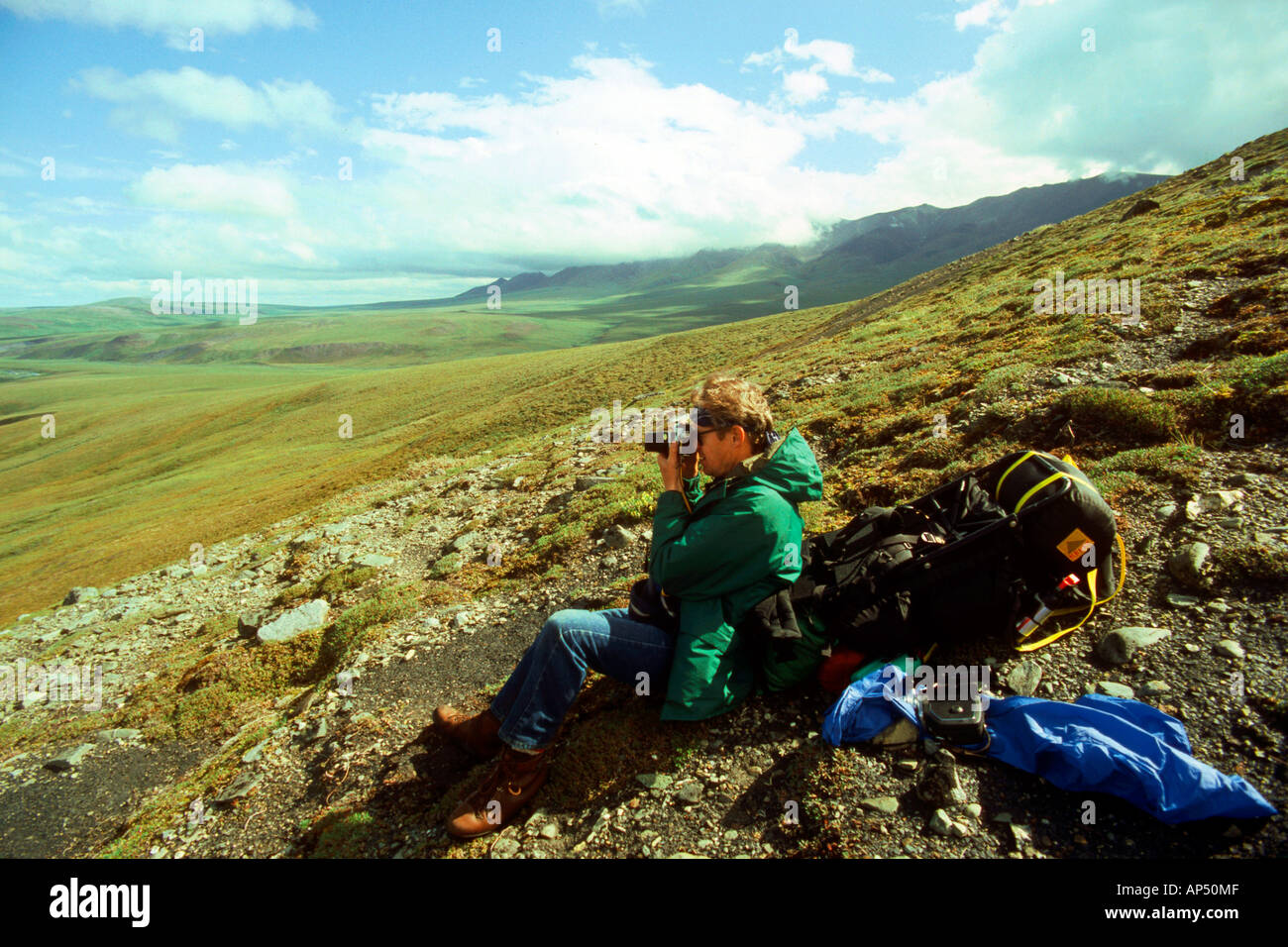 Backpacker photographer, above Kekiktuk River ANWR, Alaska, June, 1990 ...