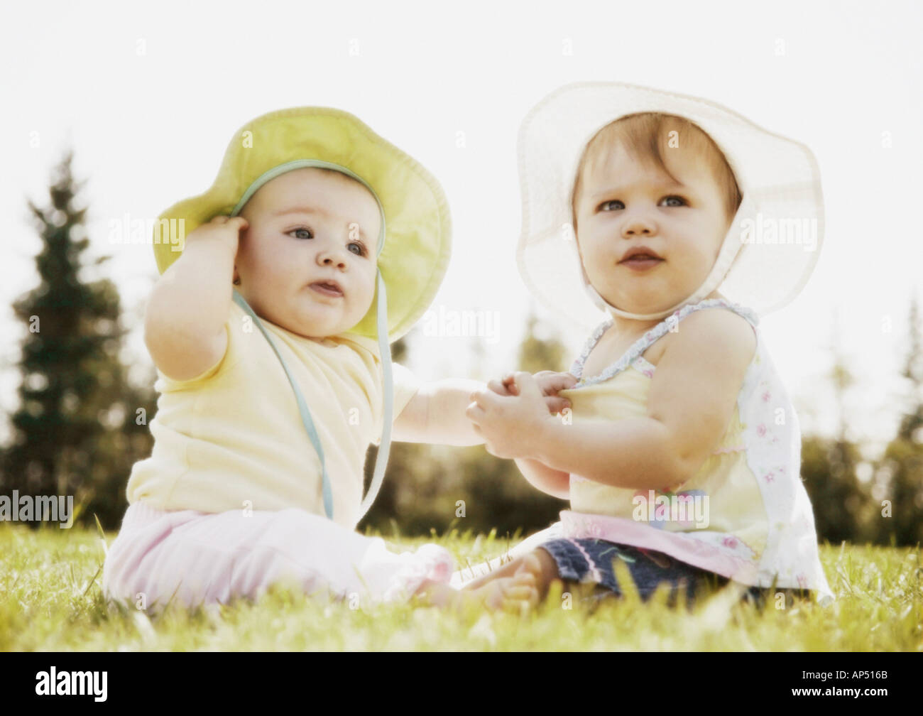 Two babies sit together Stock Photo - Alamy
