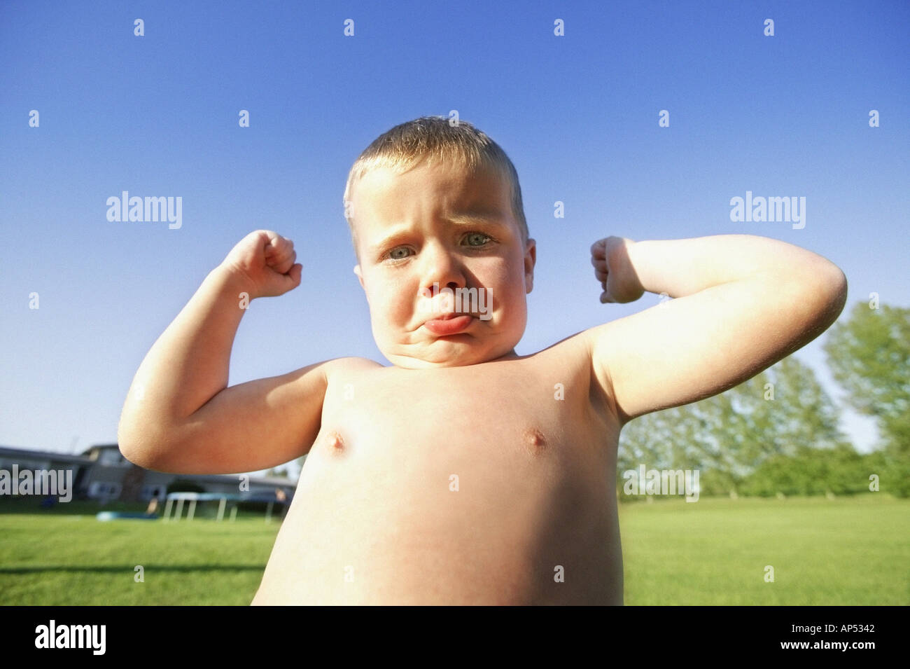 Child flexing muscles Stock Photo - Alamy