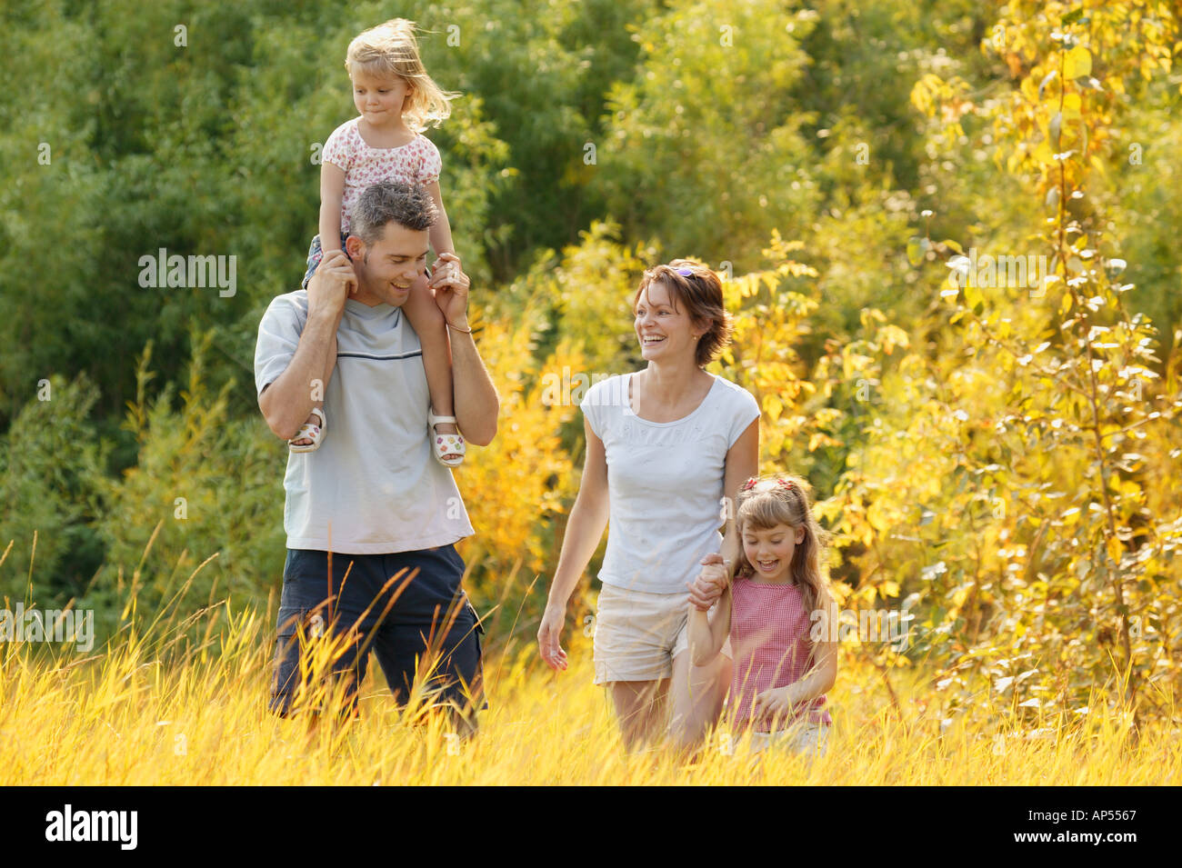 Three siblings holding hands walk hi-res stock photography and images ...