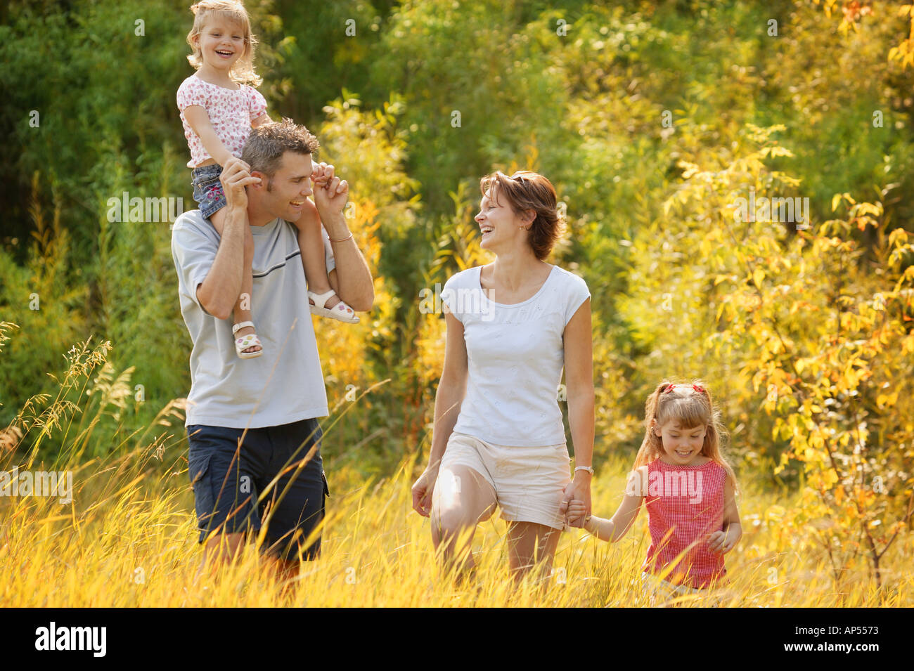 Family goes for a walk in a field Stock Photo - Alamy