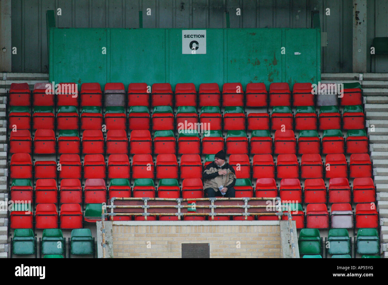 One man sat alone in an empty stadium Stock Photo - Alamy