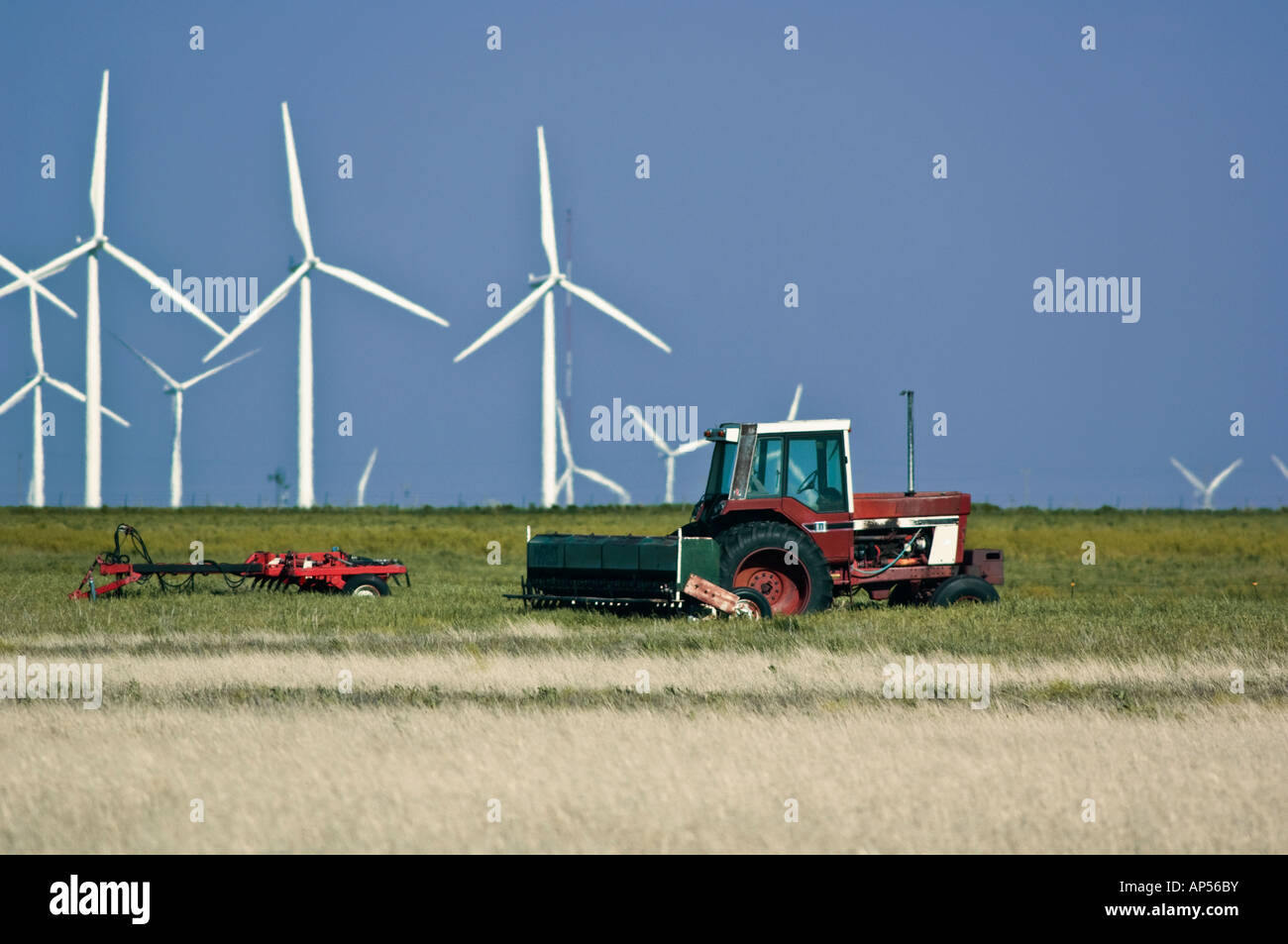 Wind turbines on Texas windfarm with tractor Stock Photo - Alamy