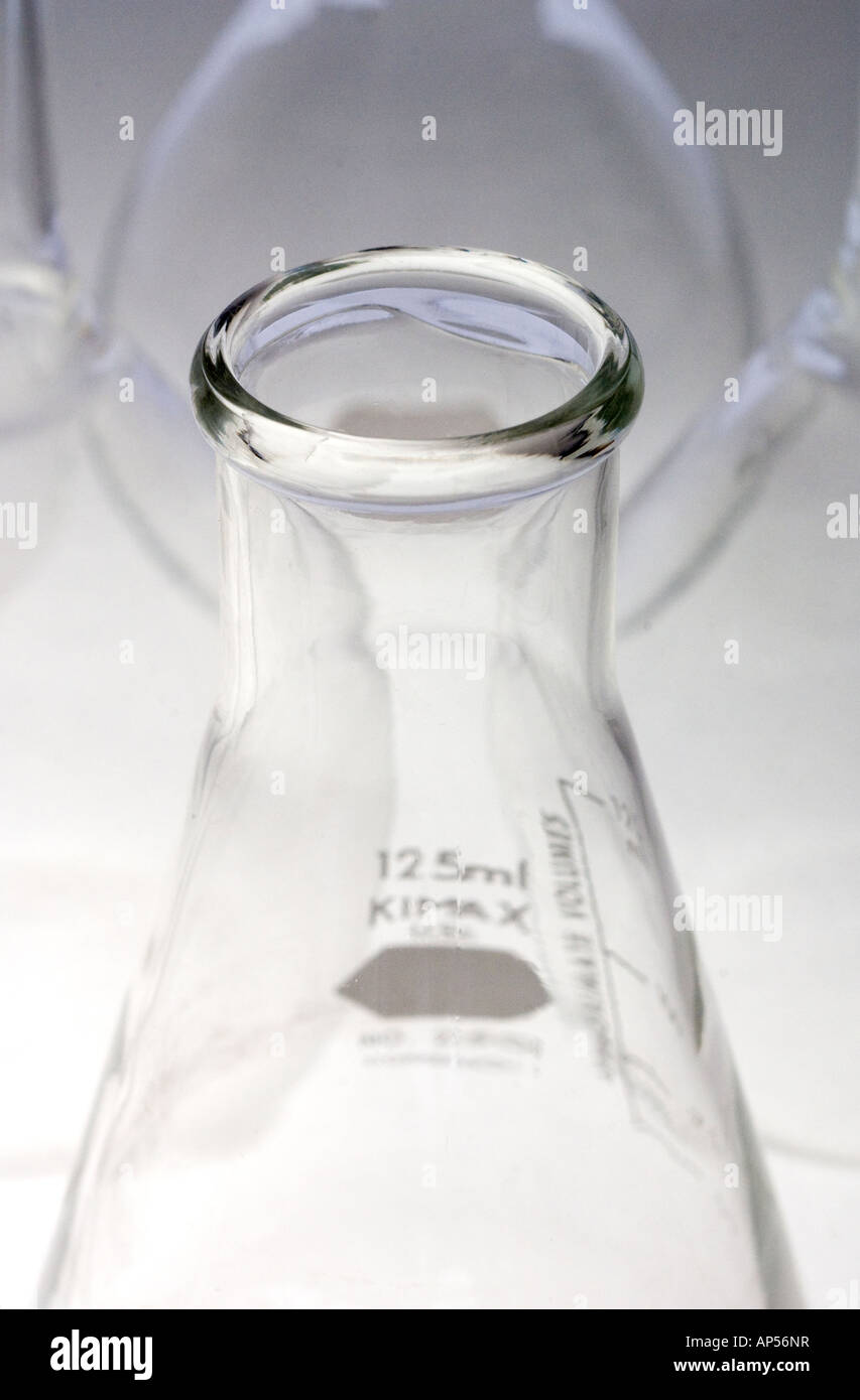 Clear laboratory flasks and glass columns representing scientific ...