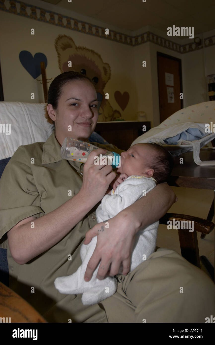 Female inmate feeding her infant son inside prison. Nebraska ...