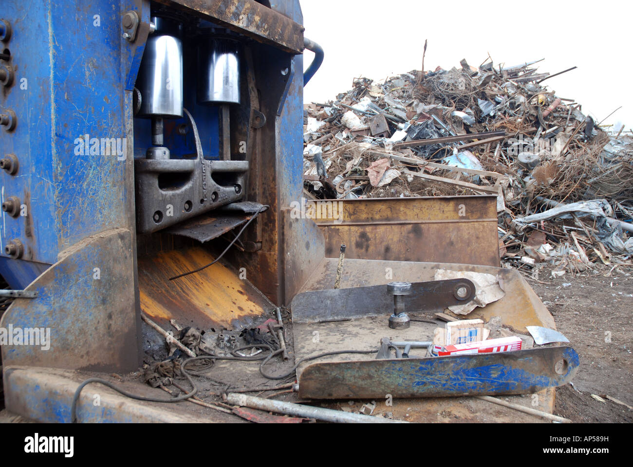Machine which pressing and cutting scrap metal for pieces on junkyard ...