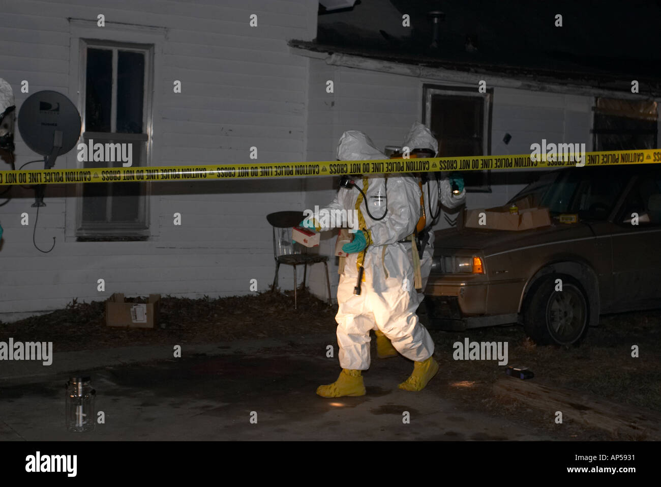 Police and deputy sheriffs investigate a methamphetamine laboratory in ...