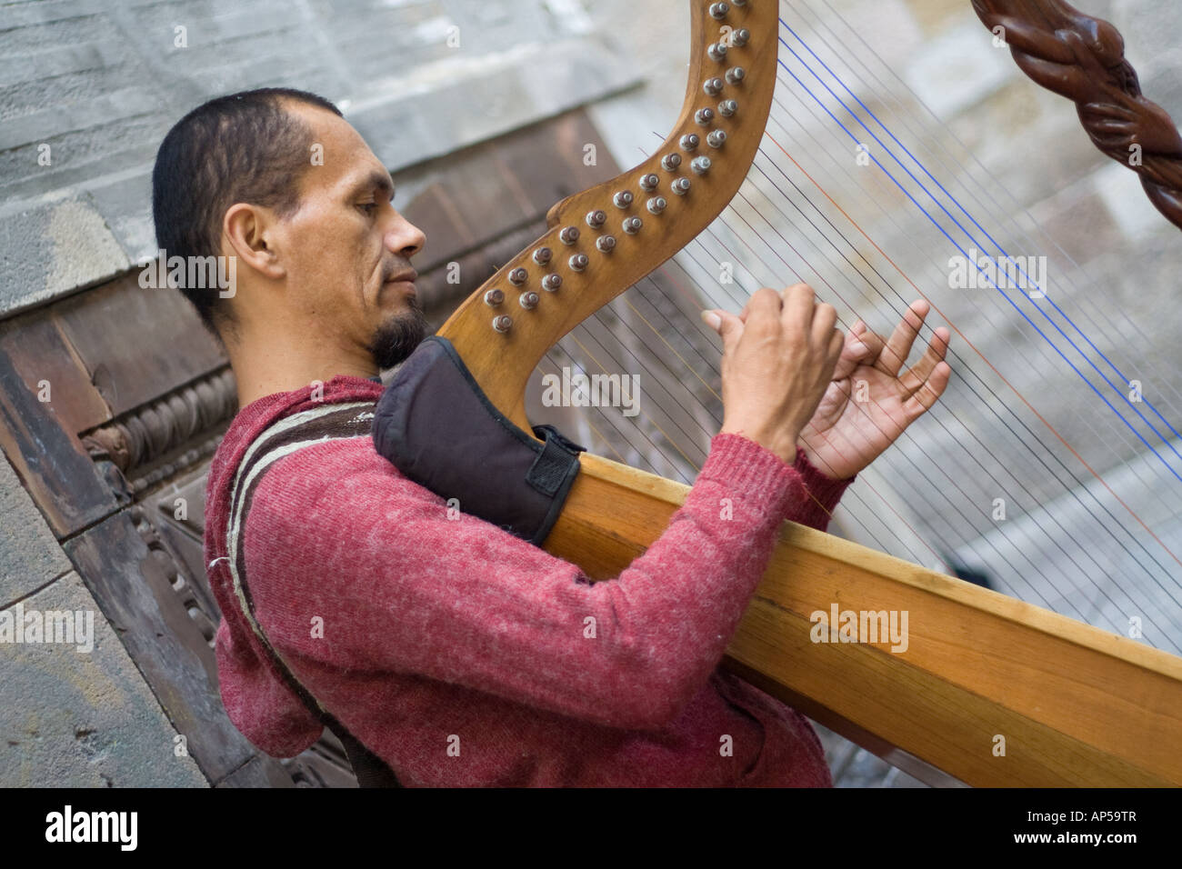 Street musician playing a harp on the sidestreet of Barcelona's Barri ...