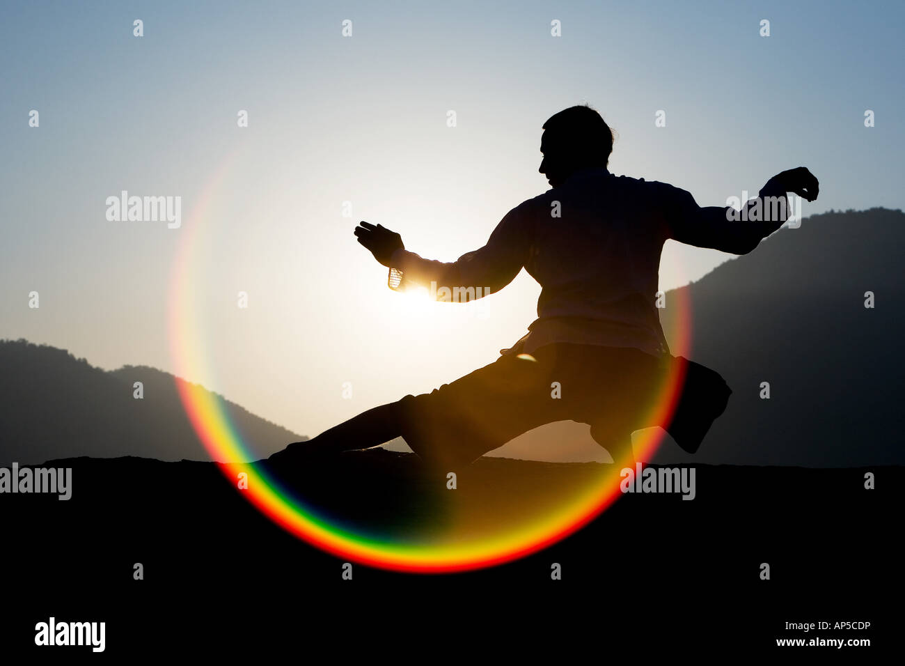 Man performing tai chi against a rising sun in india Stock Photo - Alamy
