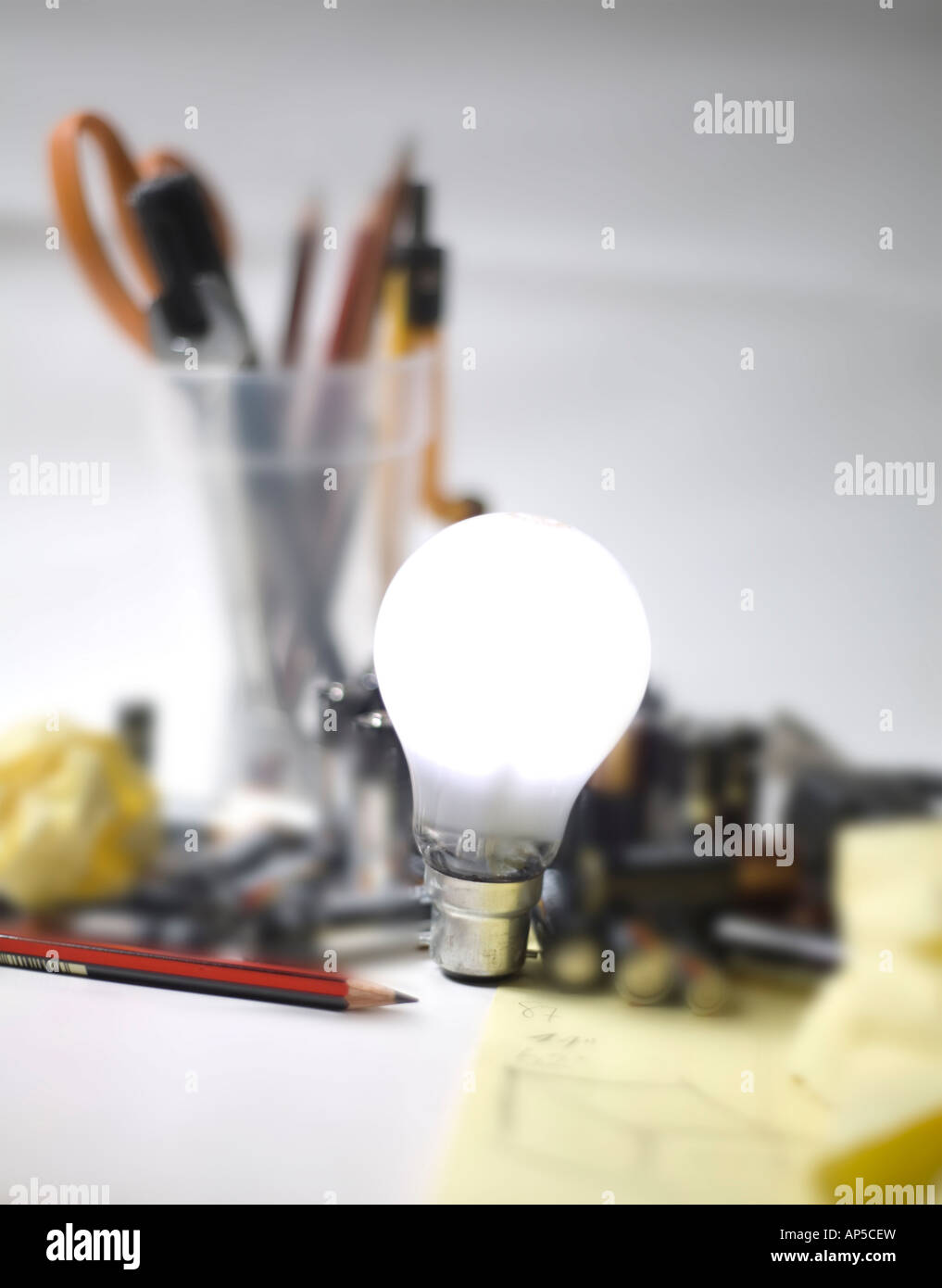 Bulb lit up and scrap from a work table Stock Photo - Alamy