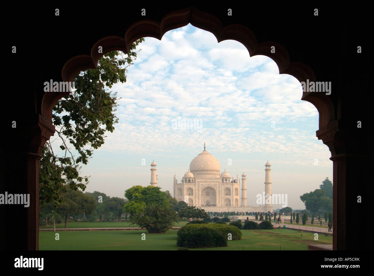 Taj Mahal distant view through arch with blue sky and white clouds Agra ...