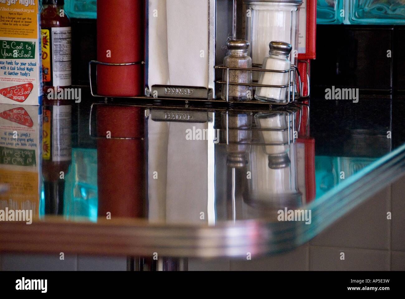 diner table condiments and napkins reflected in top Stock Photo - Alamy