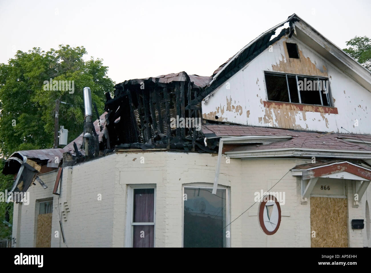 An older home in a decaying neighborhood that has been severely damaged ...