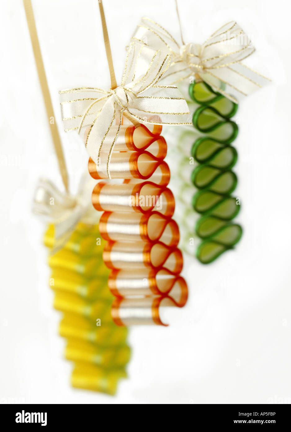 Holiday Candy Ribbons on golden strings with bows Stock Photo - Alamy