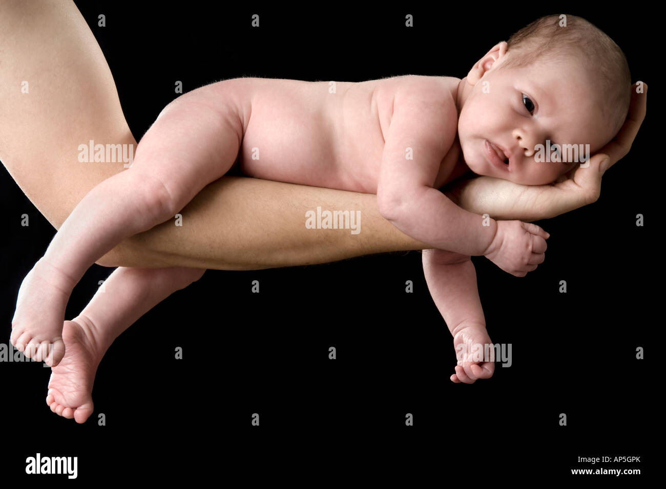 Four weeks old baby on a arm. Studio picture Stock Photo - Alamy