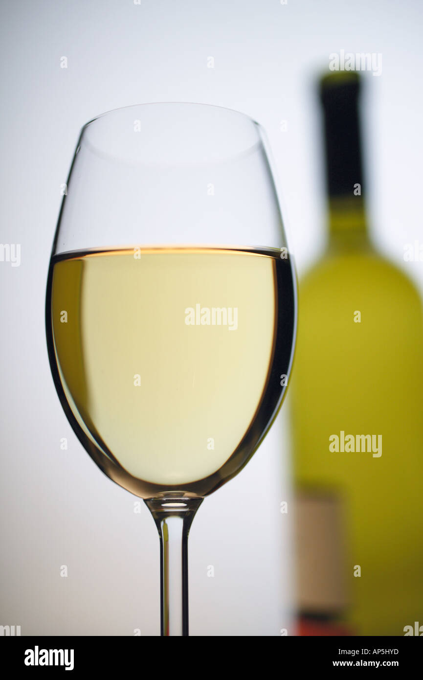 Glass Of White Wine Half Full Bottle, White Background Stock Photo - Alamy
