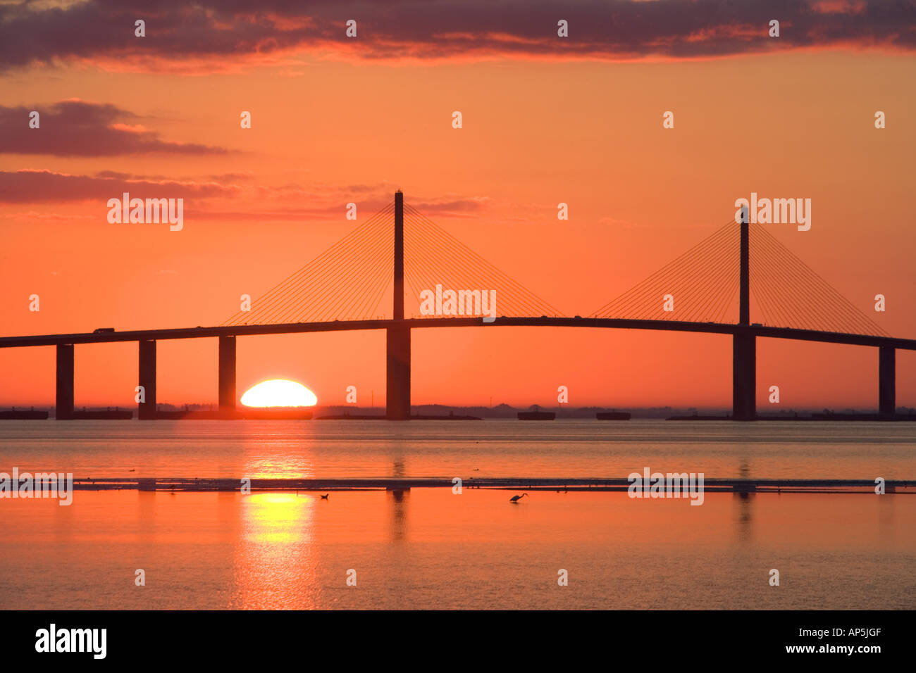 The sun rises behind the Sunshine Skyway Bridge as seen from Fort De ...