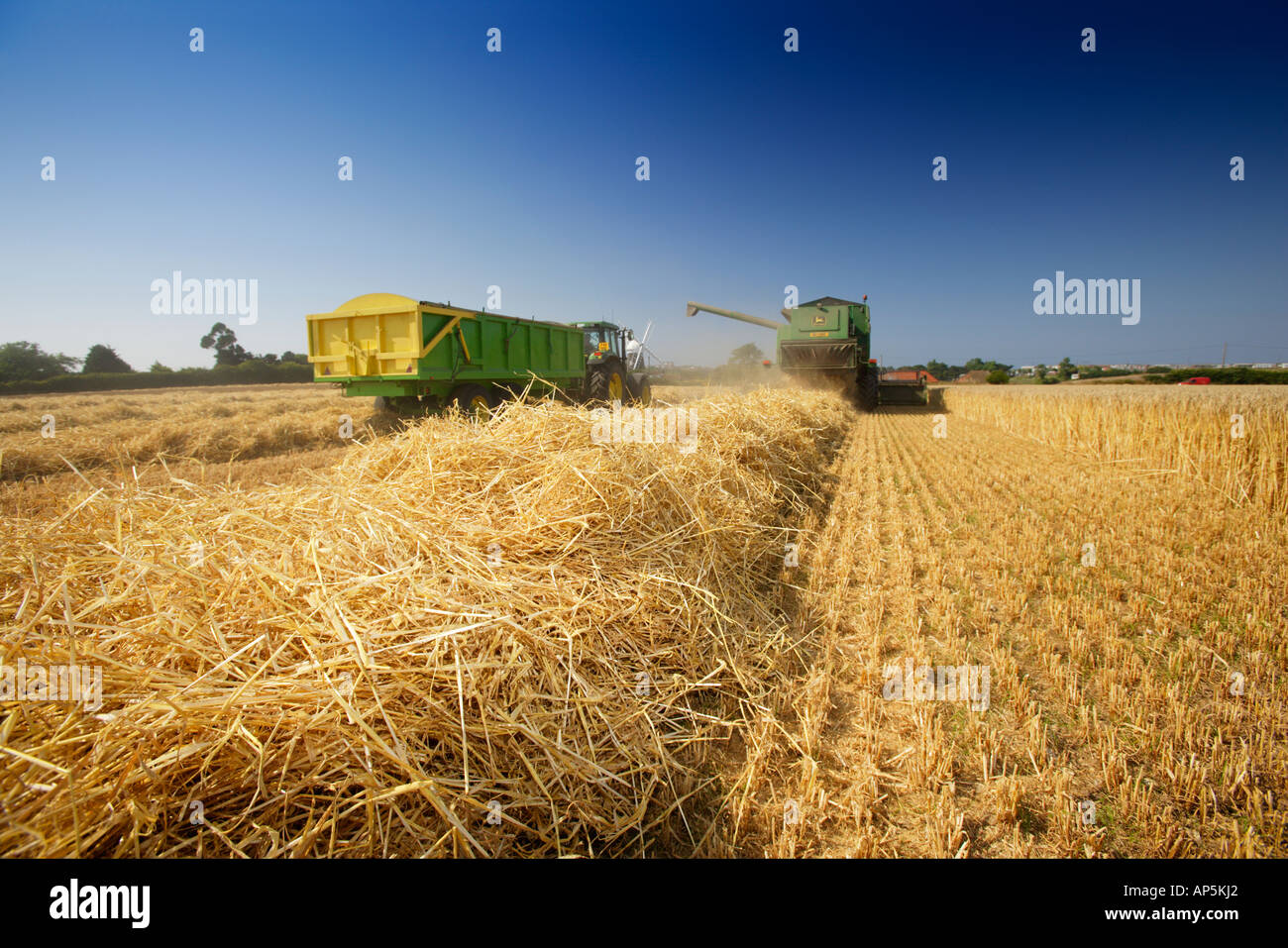 John Deere Combine Harvester and Tractor With Trailer Collecting Crop ...