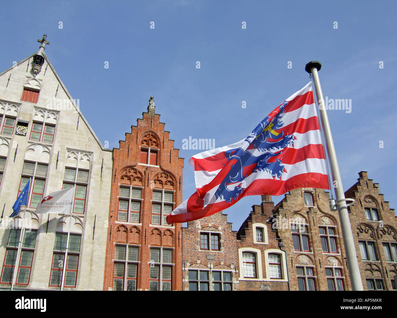 The Bruges city flag in front of traditional gable ended buildings ...