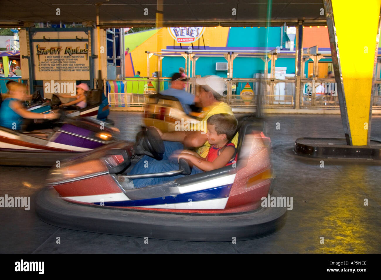 Children and adults ride bumper cars at the Iowa state fair in Des ...