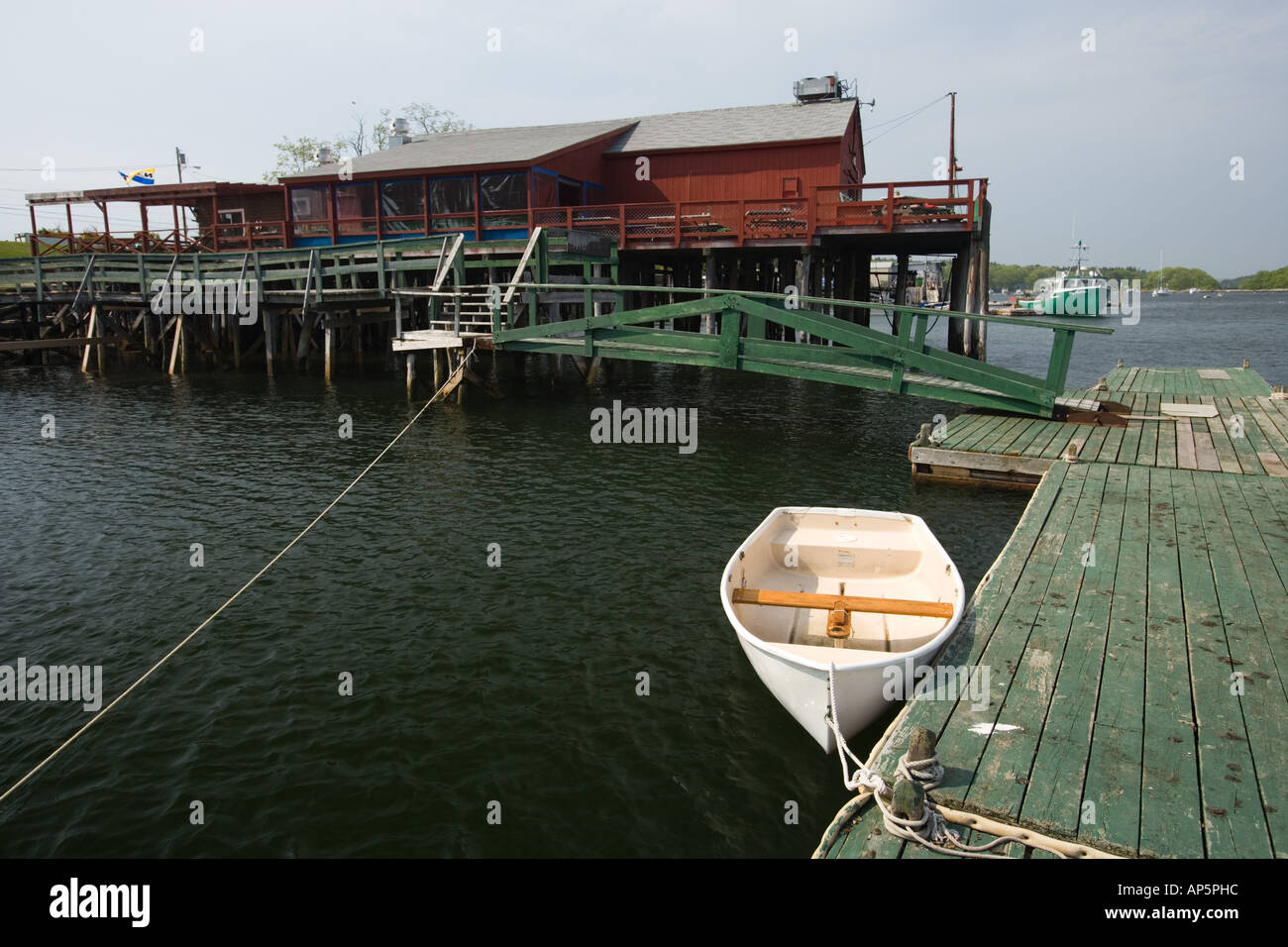 A skiff tied to the dock at Holbrook's Wharf. Cundy Harbor, Maine Stock ...