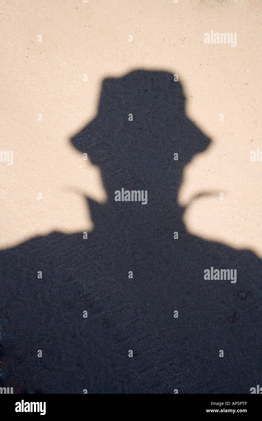 shadow of a man with panama on sand Stock Photo - Alamy