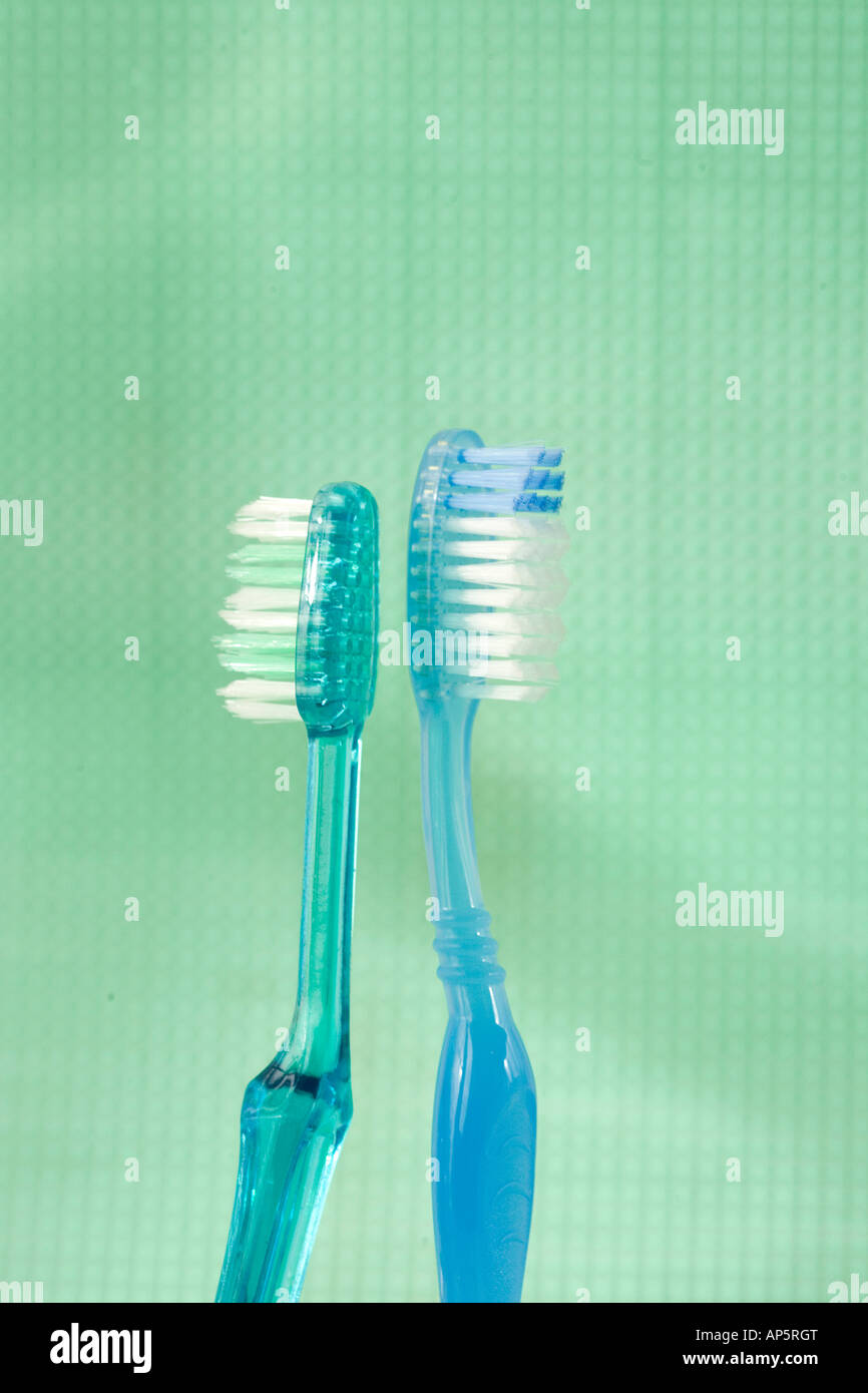 two toothbrushes green and blue back to back Stock Photo - Alamy
