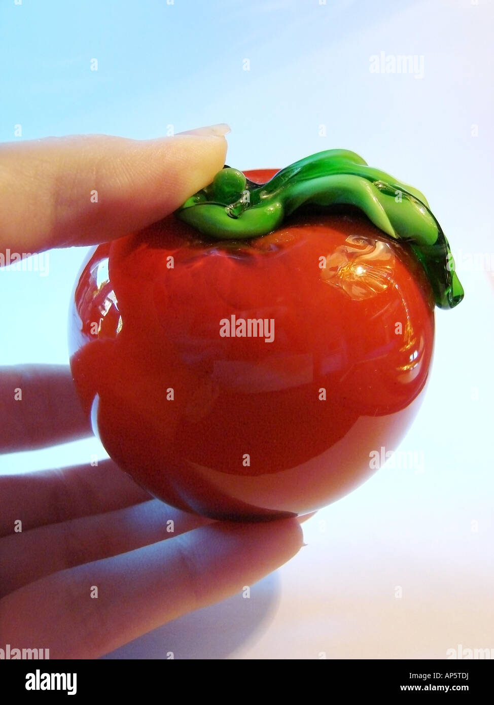 A Hand Holding a Red Glass Tomato Stock Photo - Alamy