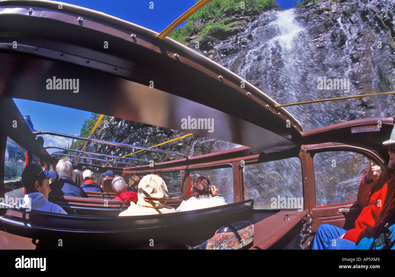 Red Jammer travels down going to the Sun Road in Glacier National Park ...