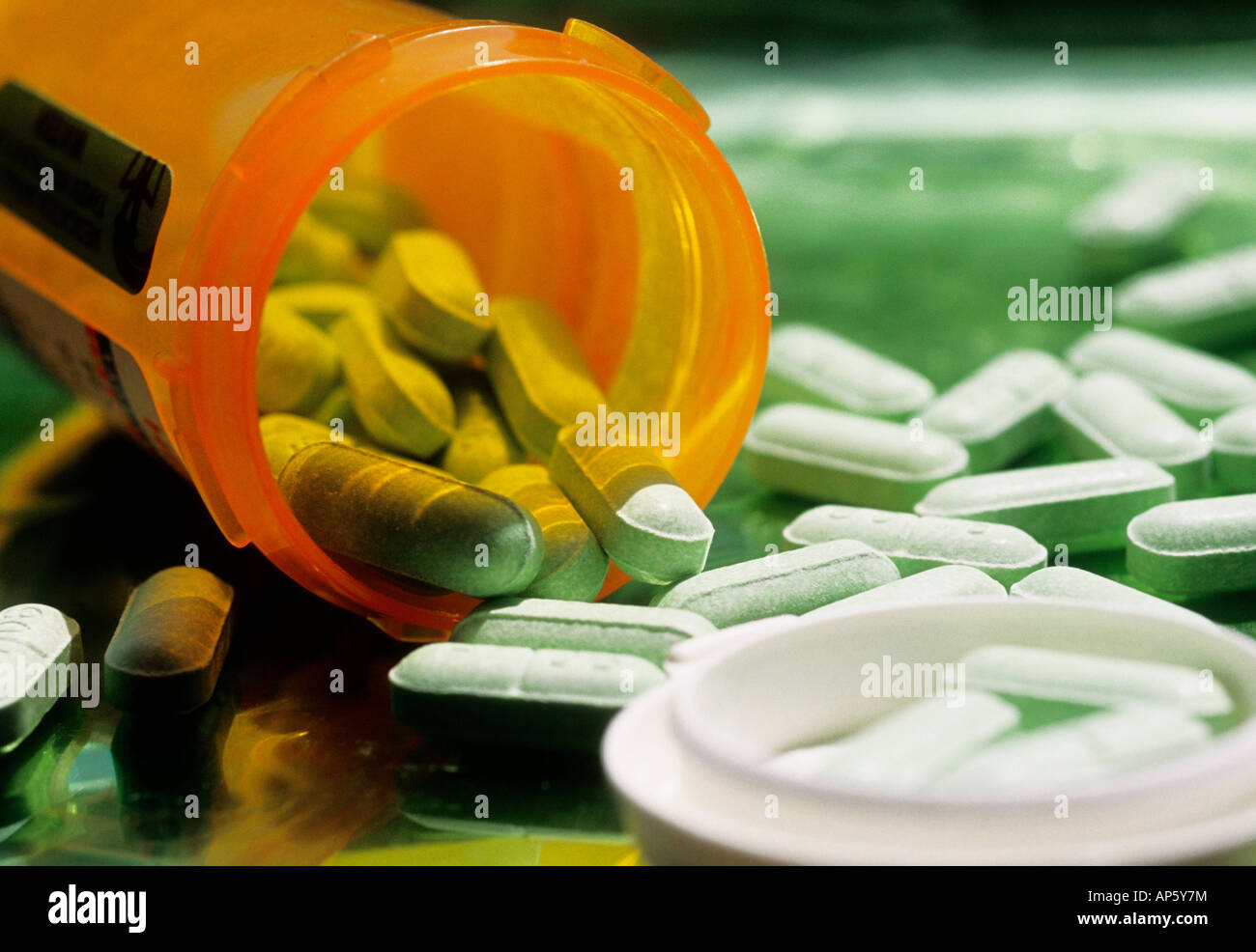 Pills spilling out of open container close up, medicine. Prescribed ...