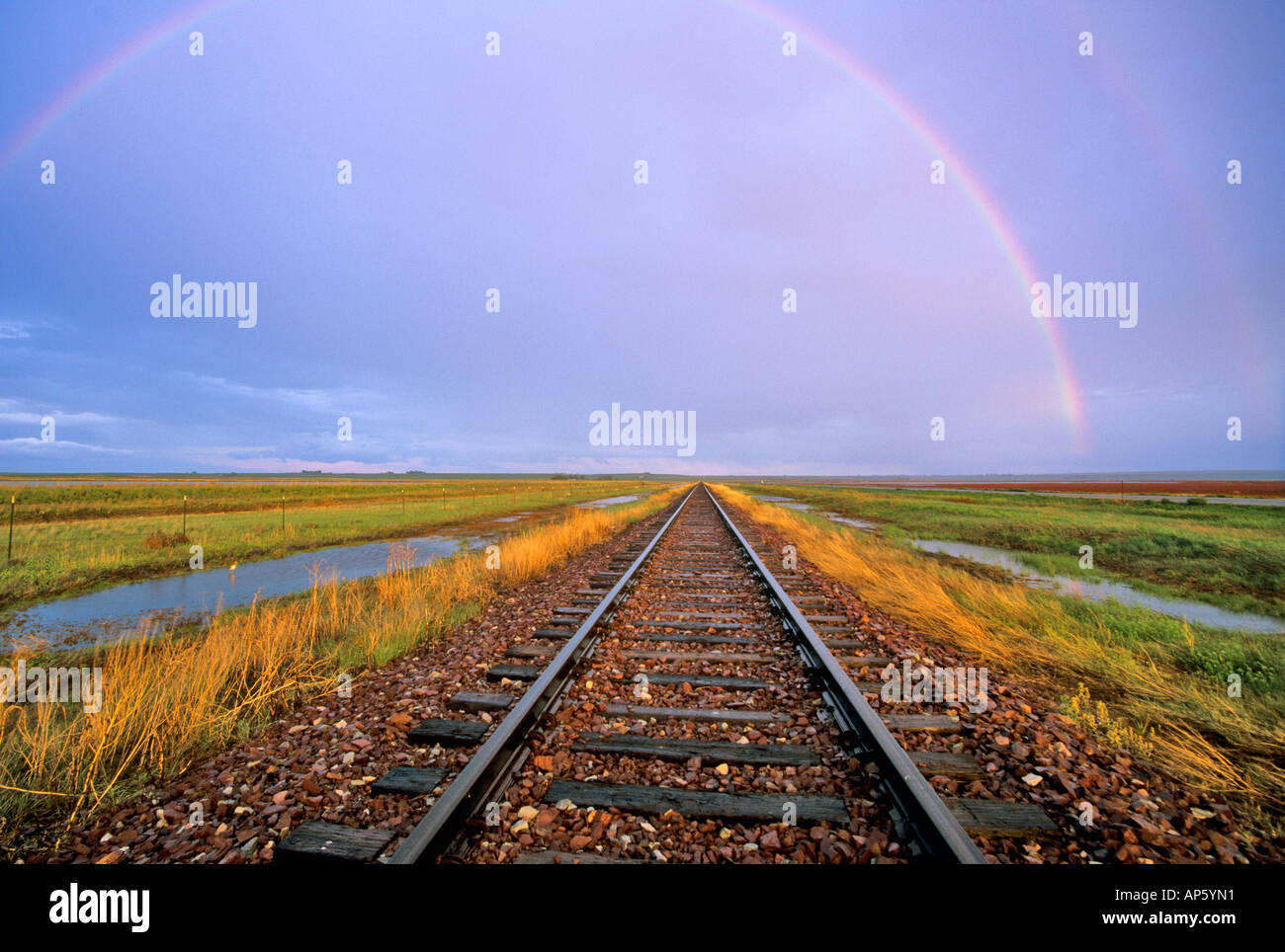 Rainbow over railroad tracks near Fairfield Montana Stock Photo - Alamy