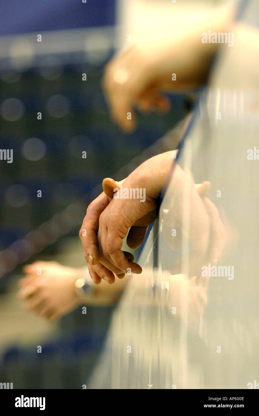 Hands over railing Stock Photo - Alamy