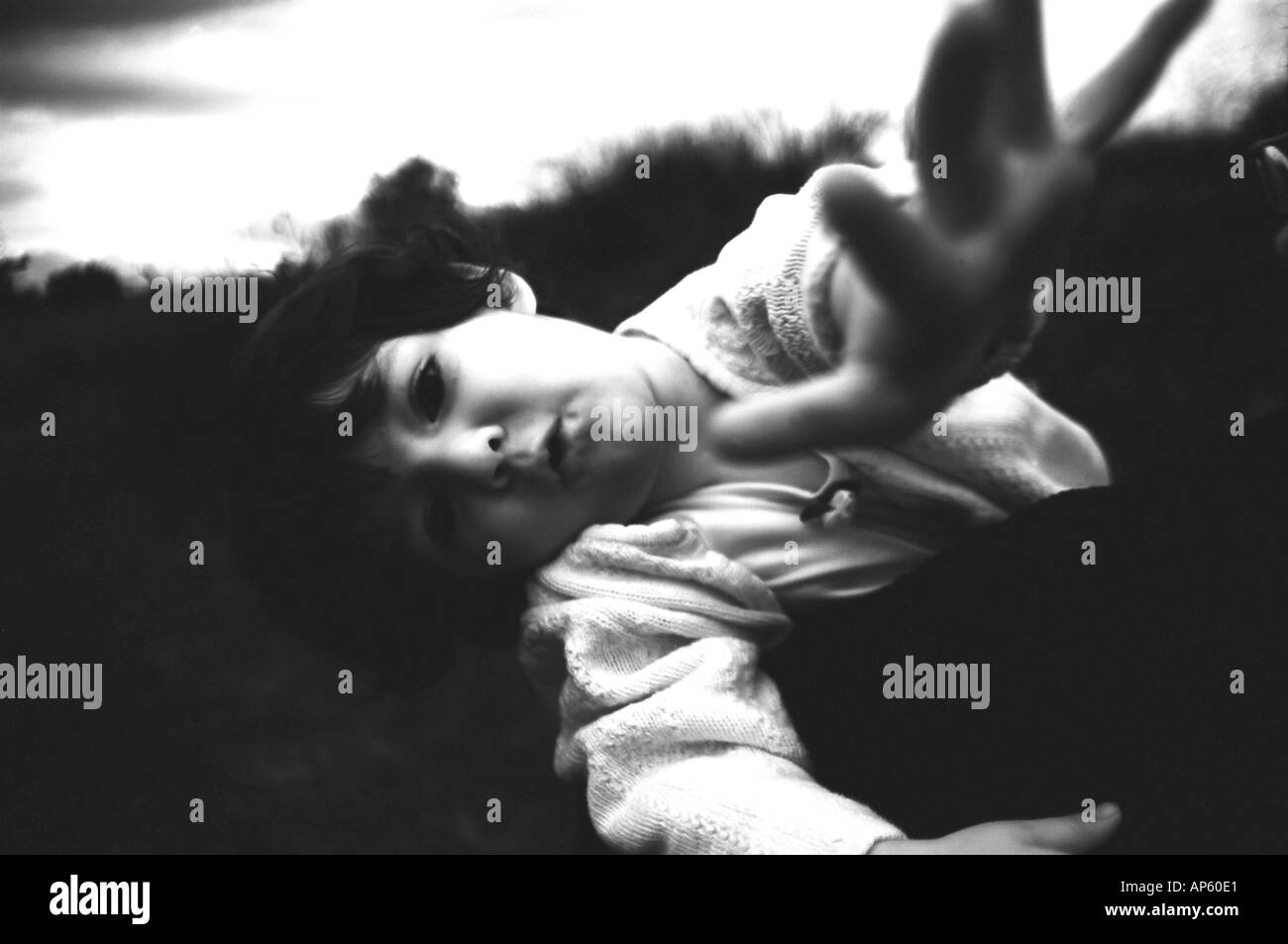 Girl reaching franticly with arms outstretched and scared look on her ...