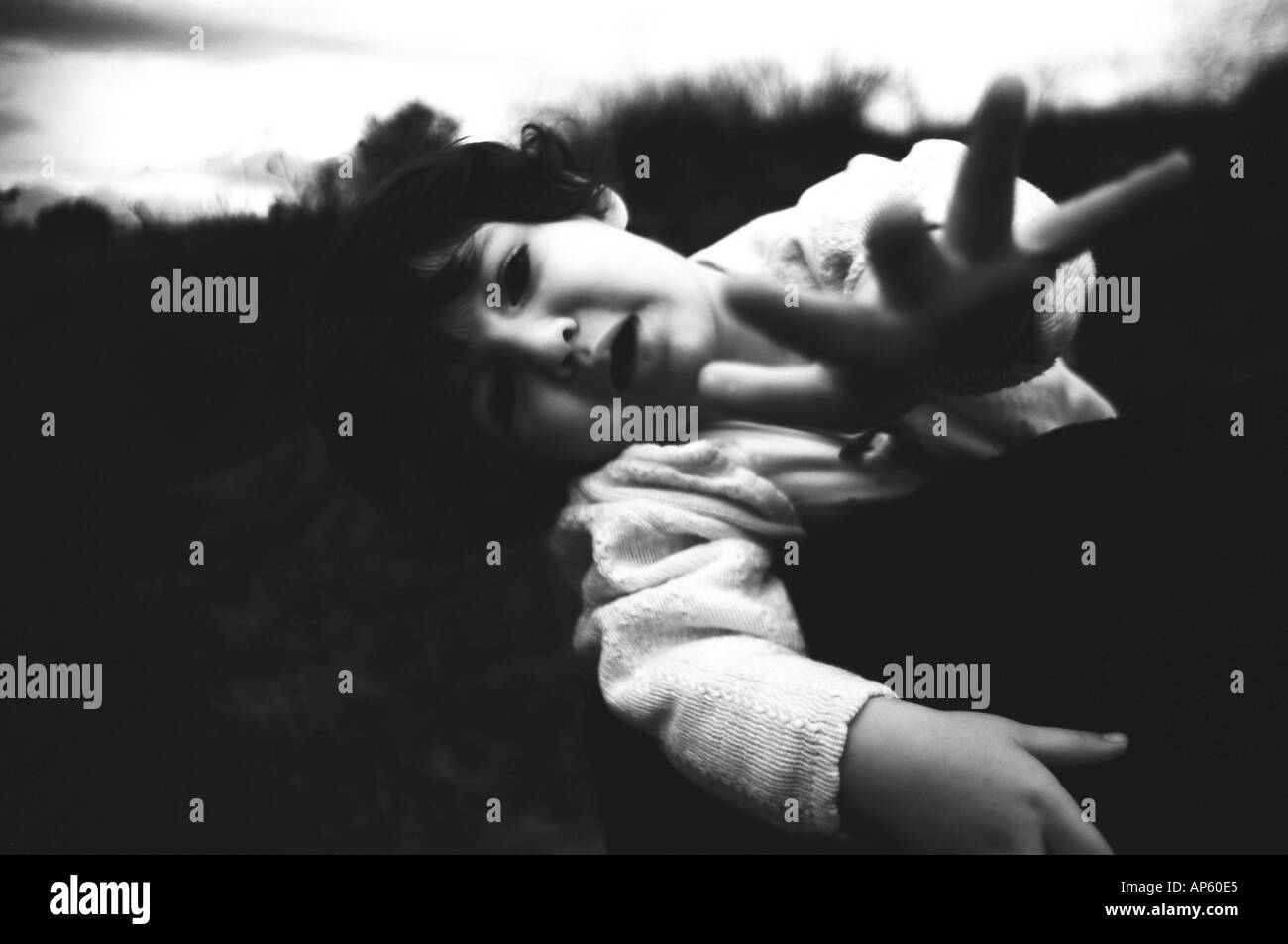 Girl reaching franticly with arms outstretched and scared look on her ...