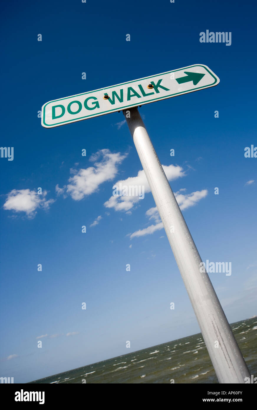Dog Walk Sign on the coast with sea, waves, and blue sky Stock Photo ...