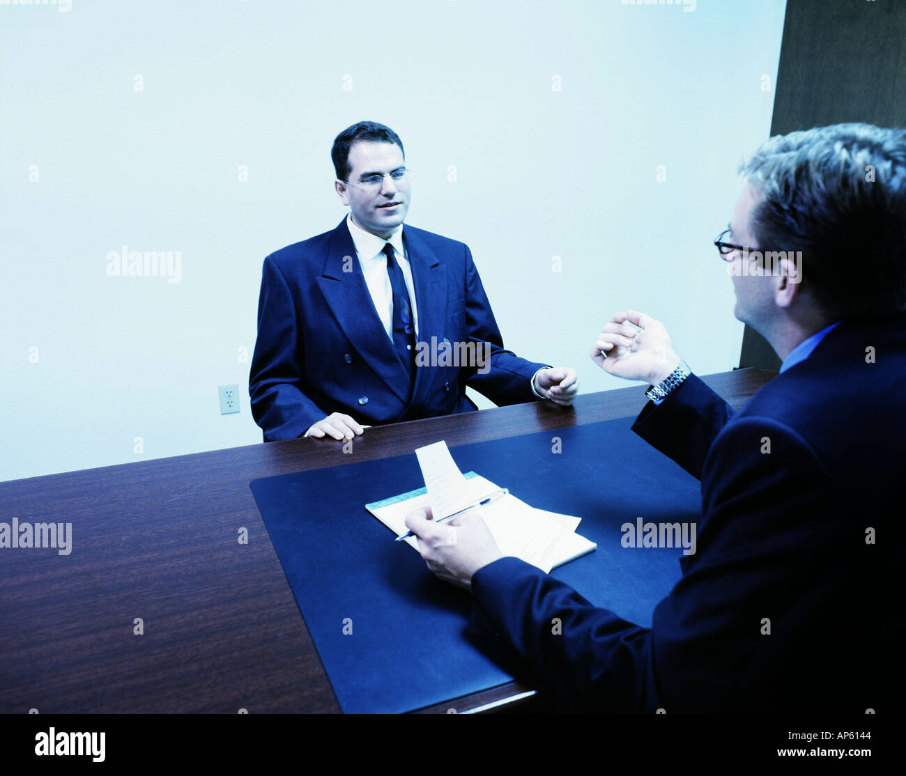 Two business men in suits one interviewing the other for a job Stock ...